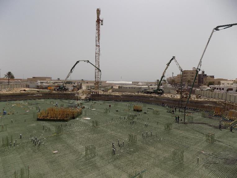 A construction site with cranes and a large buildingDescription ...